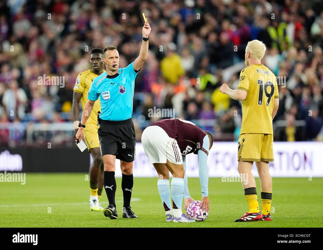 Crystal Palace's Will Hughes (right) is shown a yellow card by referee ...