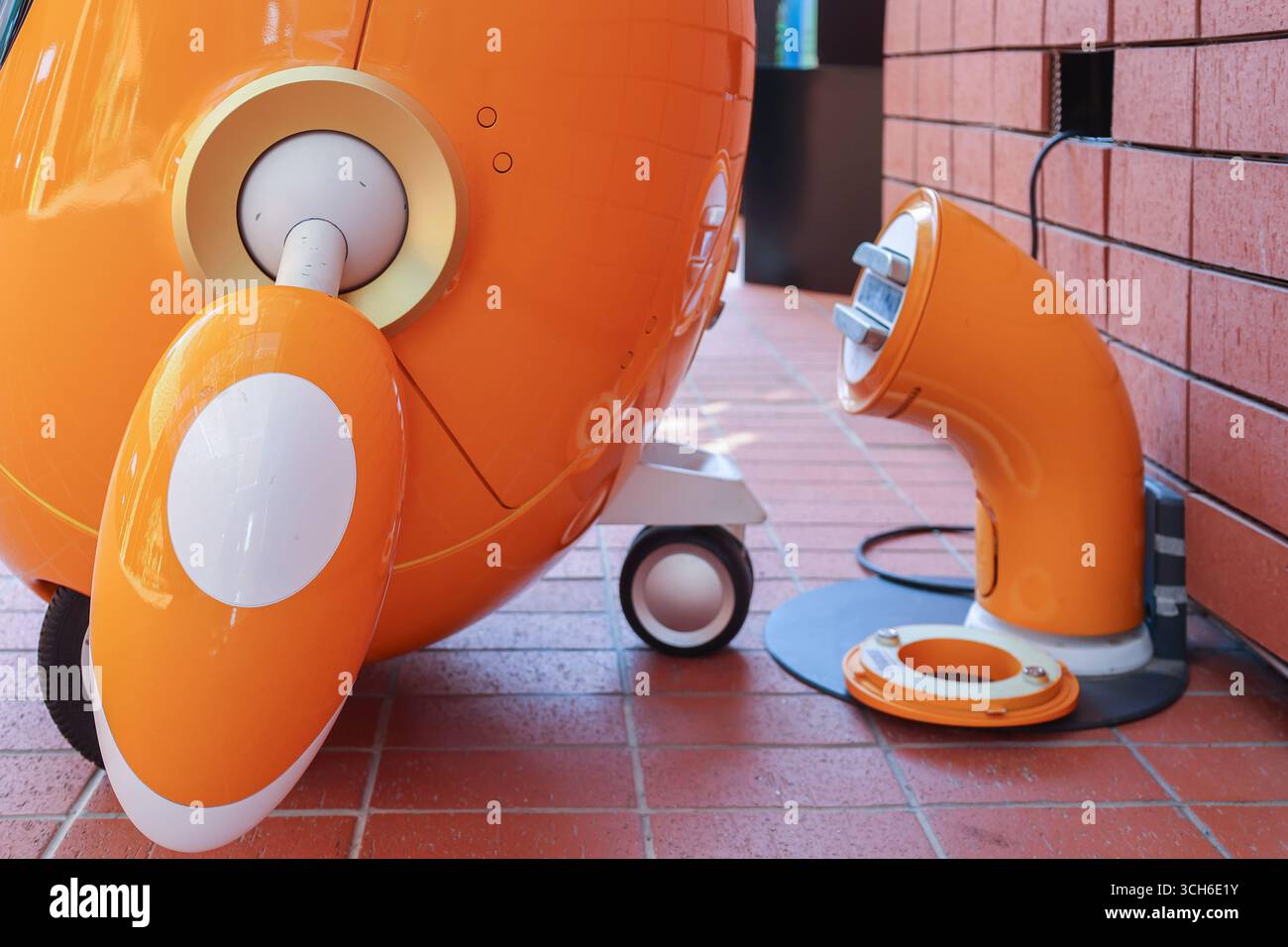 UAE, Dubai - November 28, 2021: Cute small robot Opti is charging ...