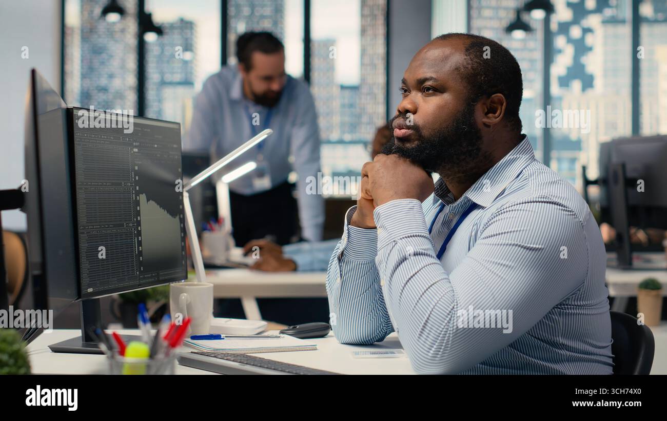 Day trader analyzes stock market price charts, doing thinking, making ...
