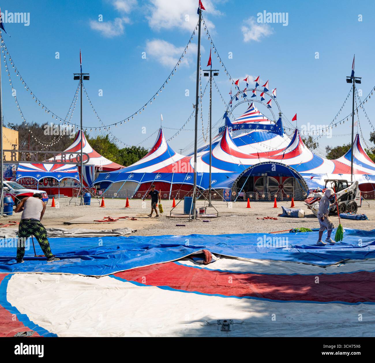 Workers cleaning up a large circus tent along Avenida Paseo de los ...