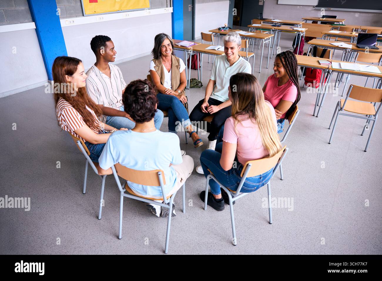High school students and teacher talking in a circle in classroom Stock ...