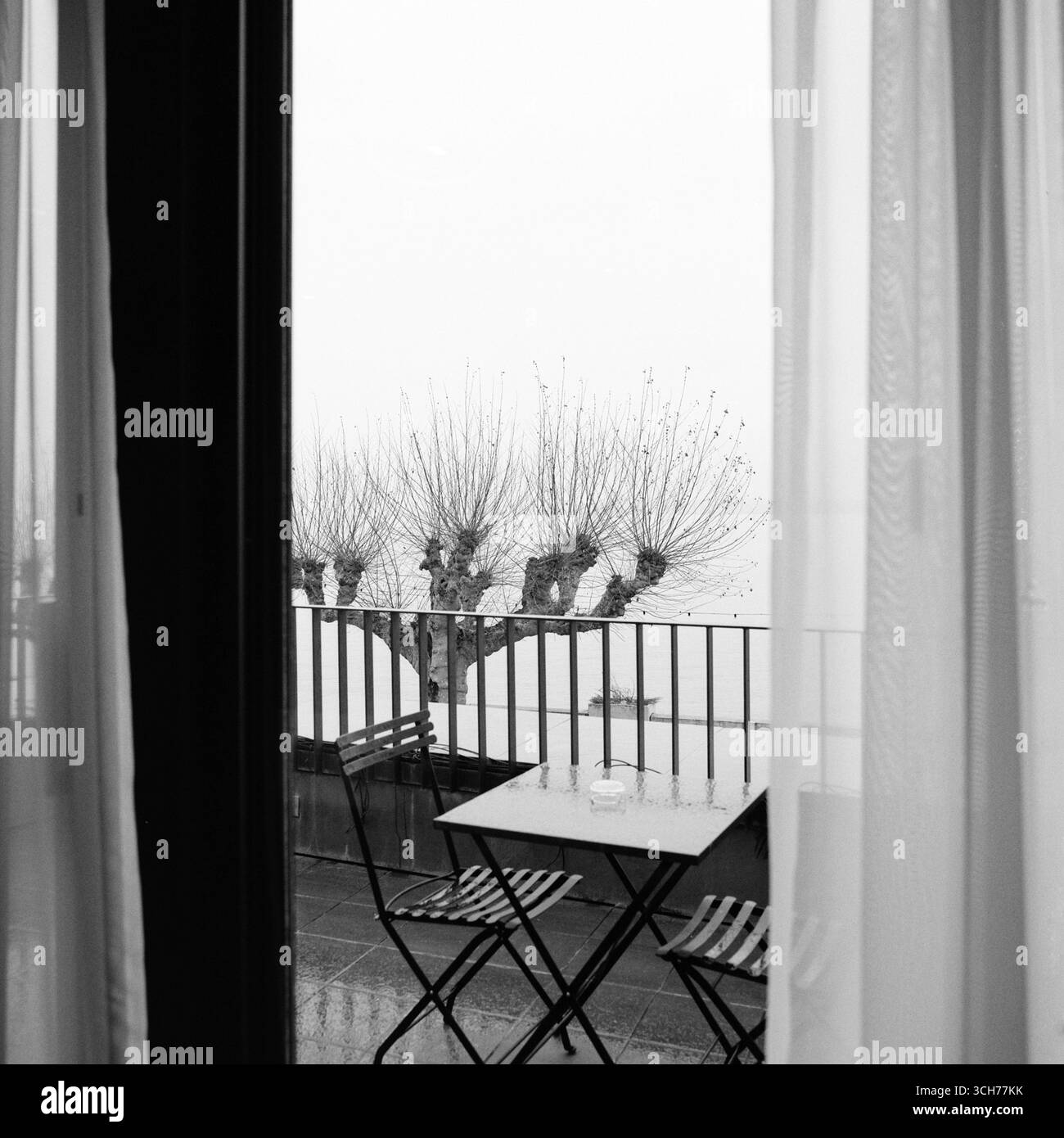 Black and white medium format photograph showing a rainy, overcast view ...