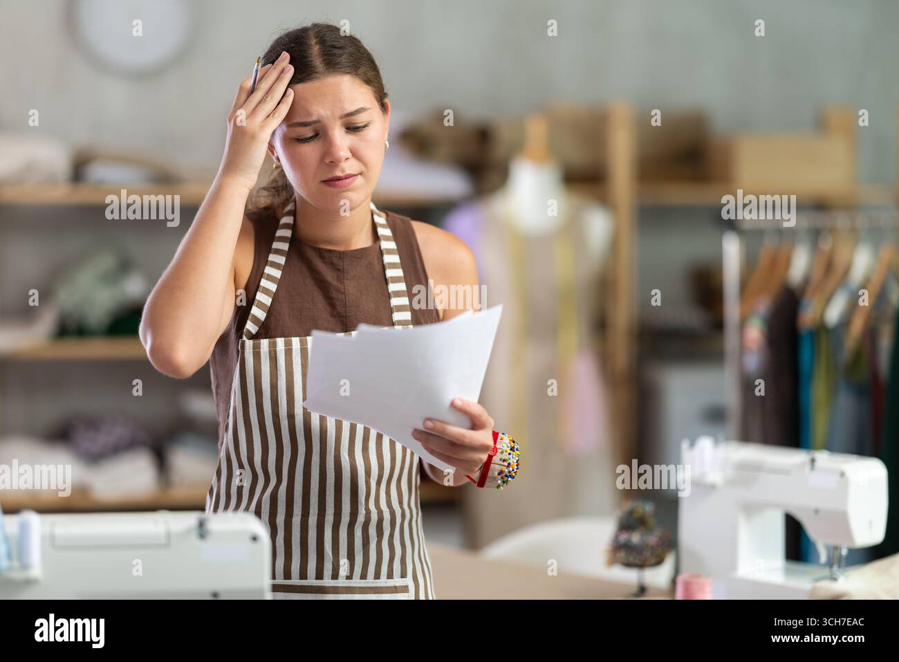 Woman looks accounting documents hi-res stock photography and images ...