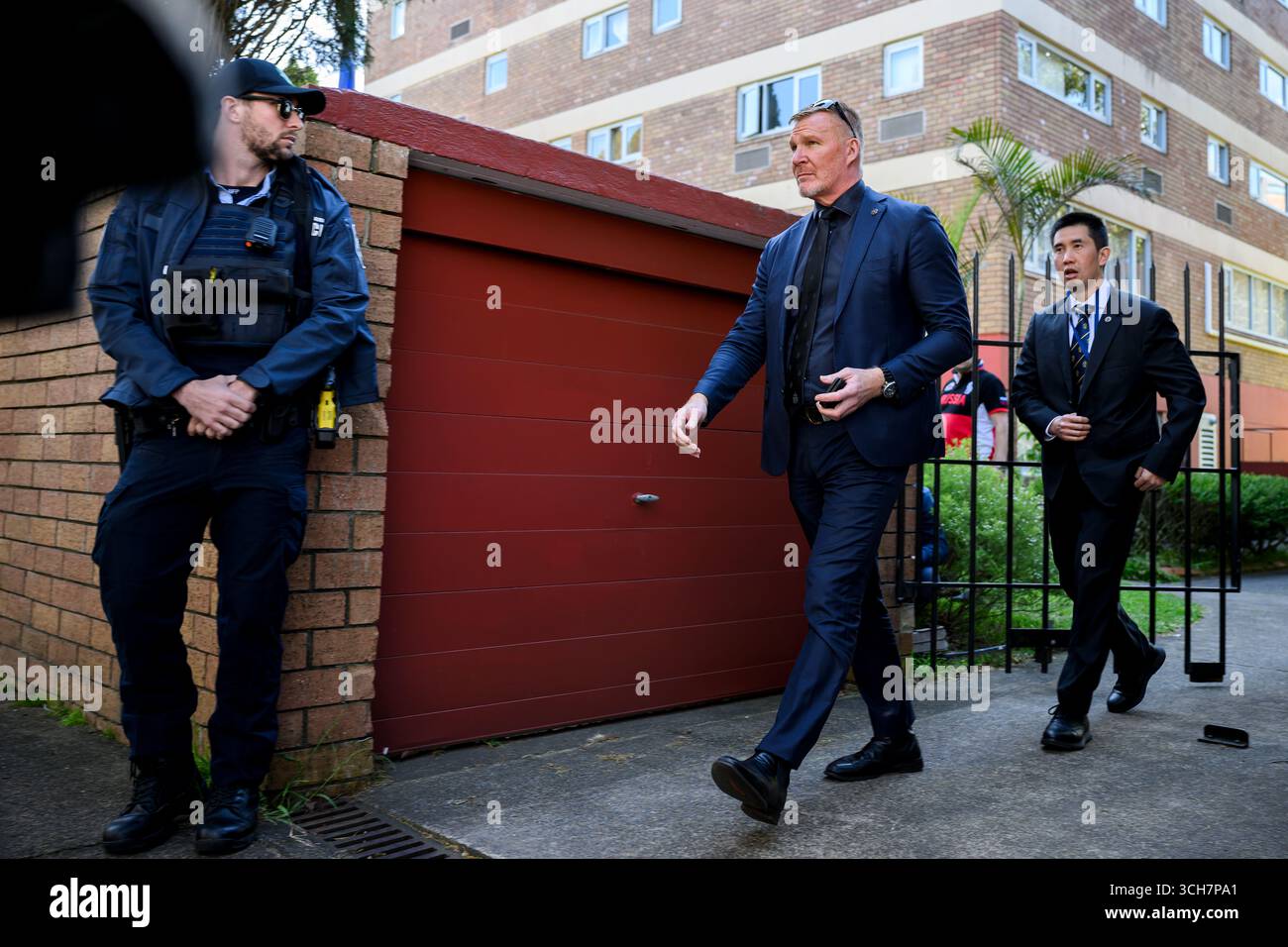 Detectives and Australian Federal Police (AFP) are seen at the scene of ...