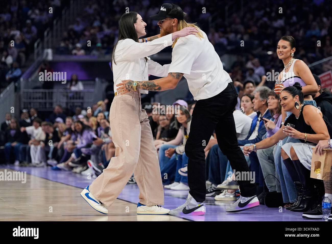 Indiana Fever's Caitlin Clark, left, hugs San Francisco 49ers' George ...