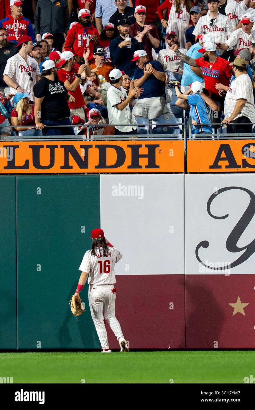 Philadelphia Phillies left fielder Brandon Marsh (16) looks on as a fan ...
