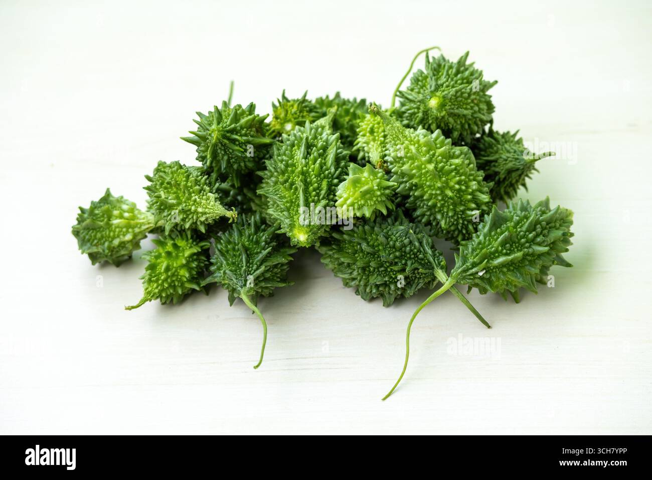 Bunch of fresh bitter melon on white background. Its scientific name is ...