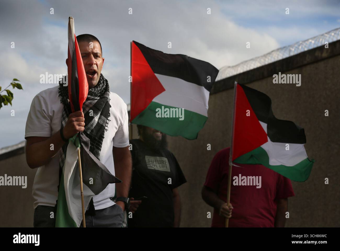 A protester holds a Palestinian flag as he chants his message during ...