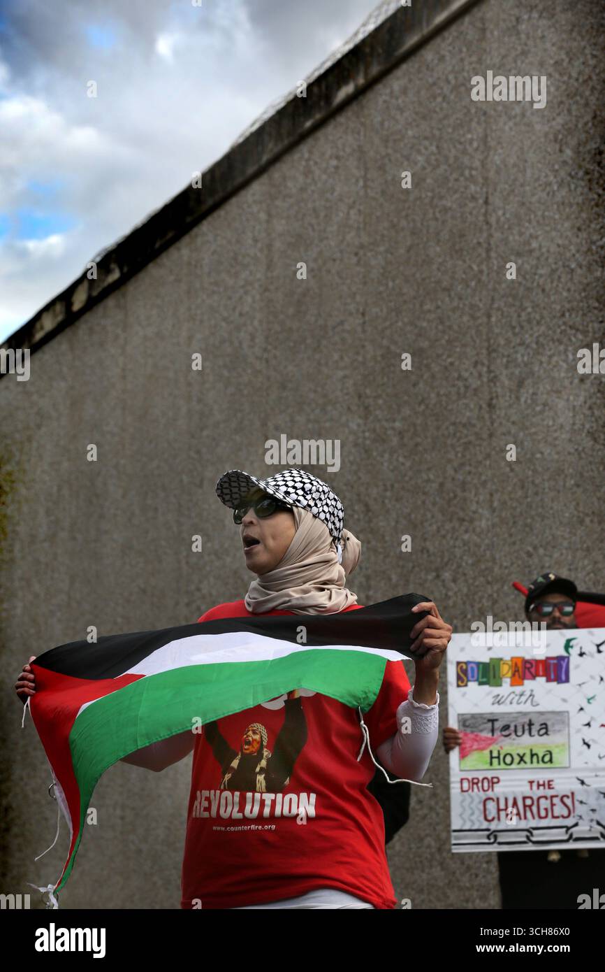 Protesters gather outside HMP Peterborough with placards and flags ...