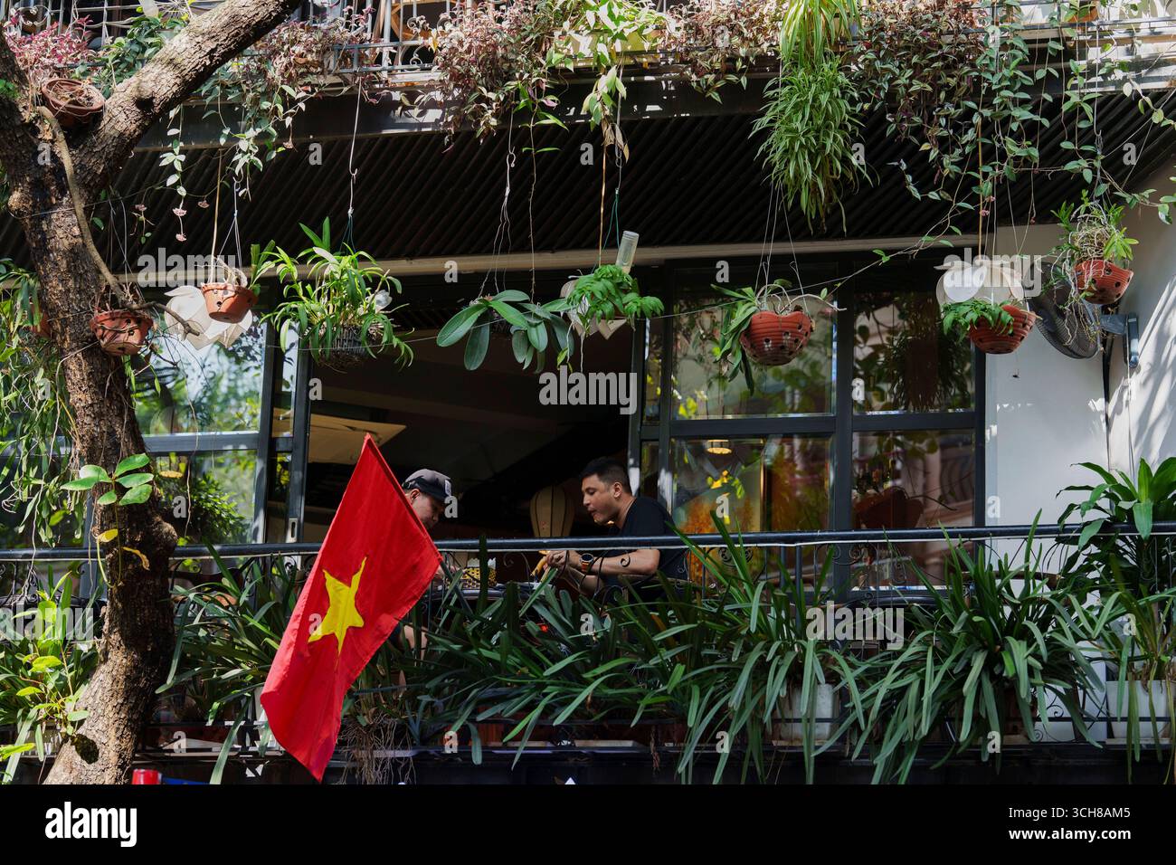 A Vietnamese national flag flies from a balcony in the old quarter of ...