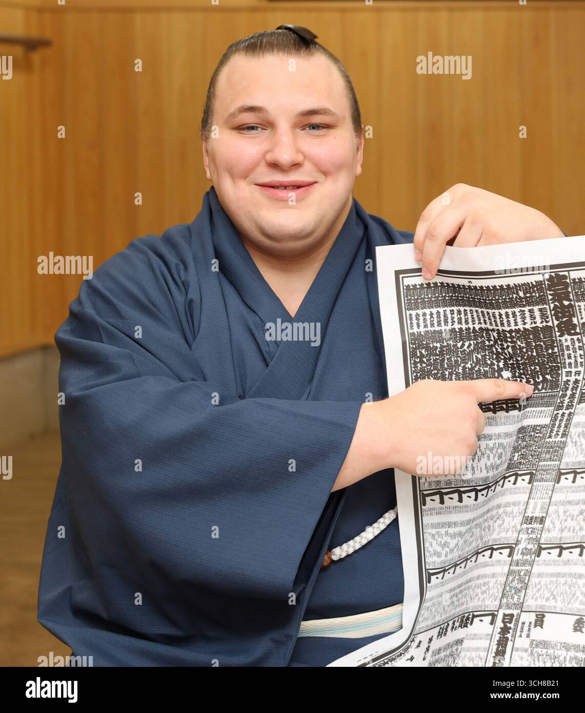 Aonishiki Arata of Ukraine points to his own name after being promoted ...