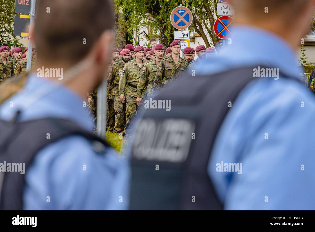Police officers stand in formation during a Bundeswehr parade, ensuring ...