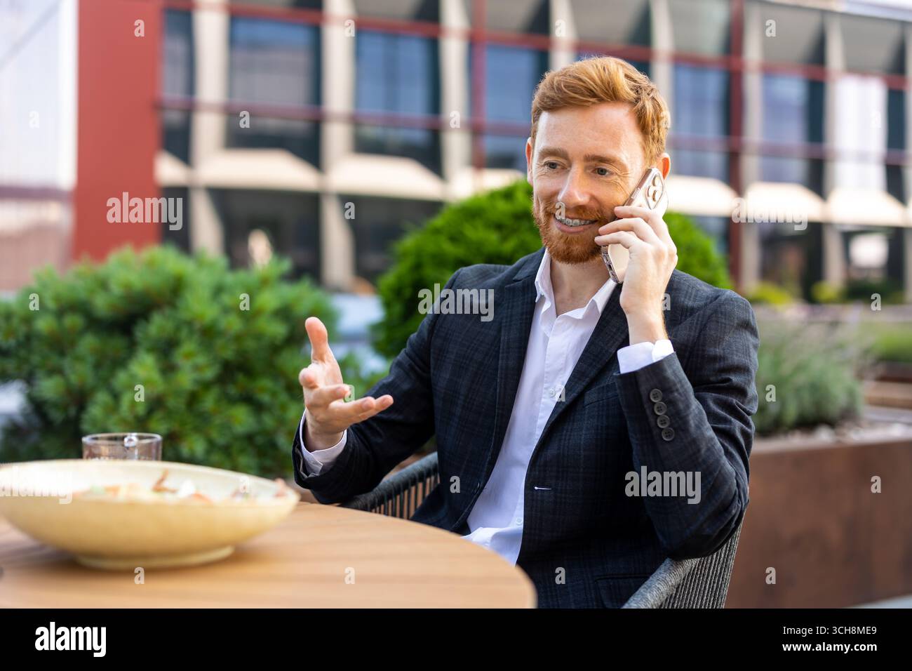 Bearded worker having mobile conversation during lunch time Stock Photo ...