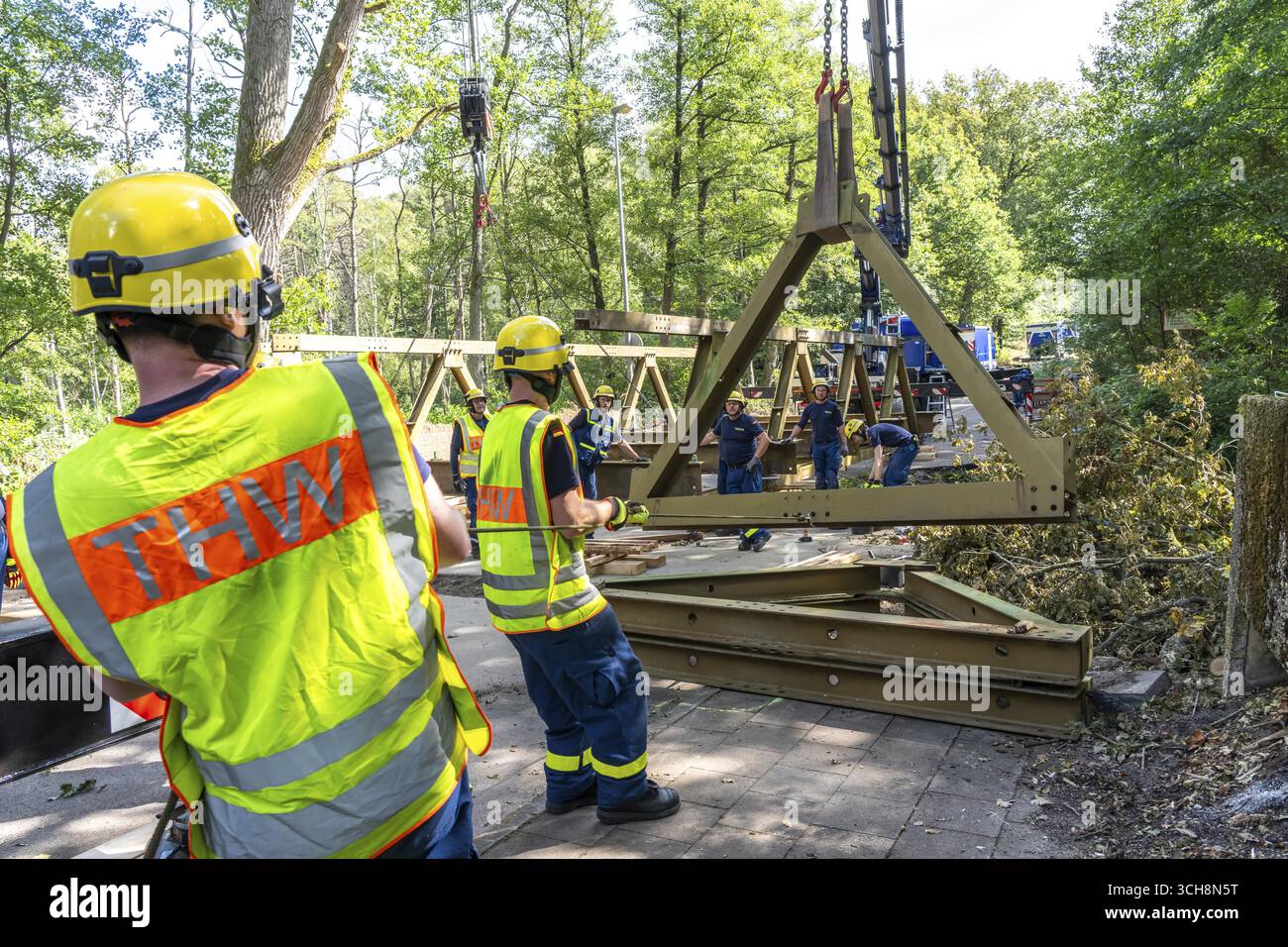 Construction of a temporary bridge over a slipped road crossing a ...