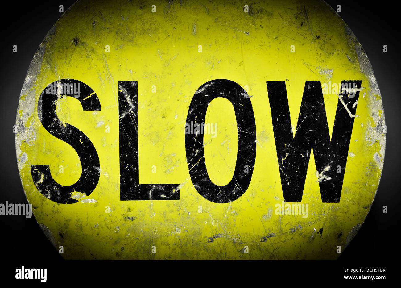 Yellow slow caution sign Stock Photo - Alamy