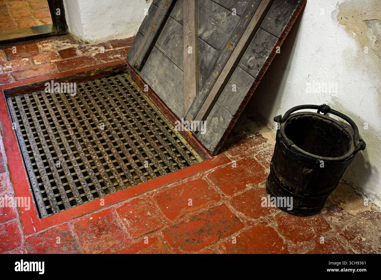 Open trapdoor revealing a grate or oubliette in a medieval castle, with ...
