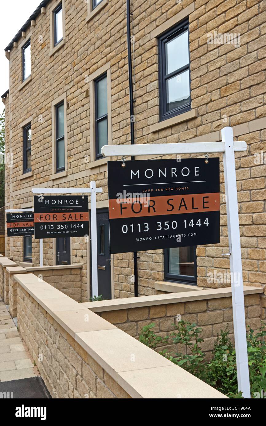For Sale boards outside new build houses, Hebden Bridge Stock Photo - Alamy