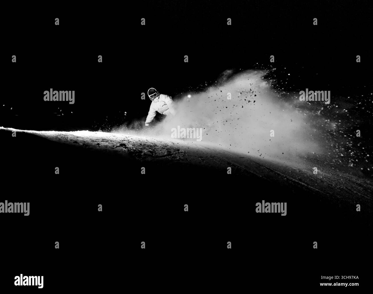 Professional snowboarder Colin Spencer spraying snow at night Stock ...