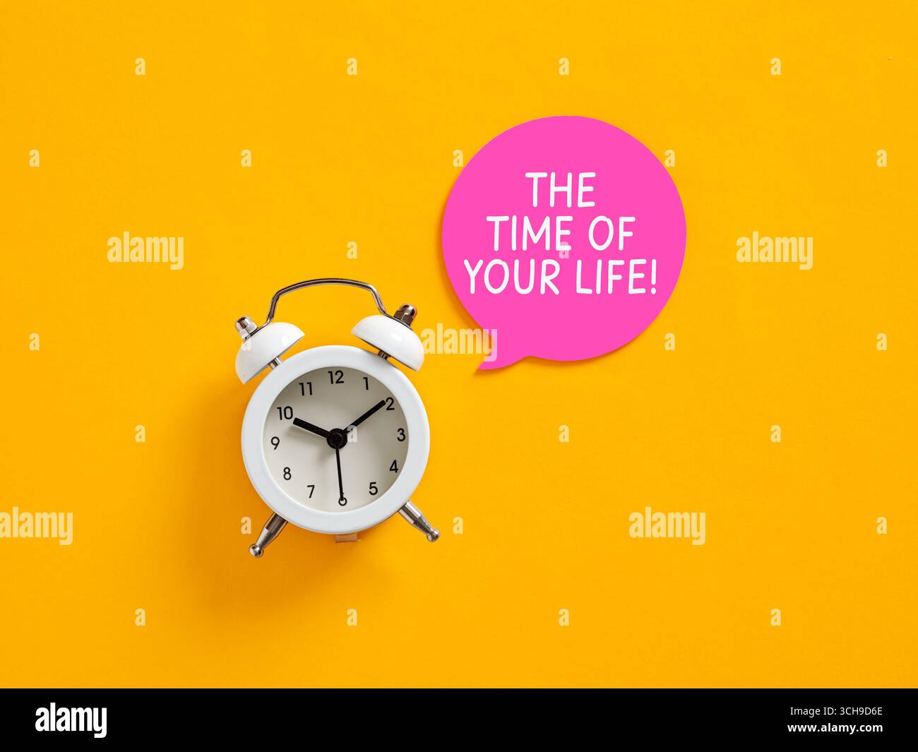 White alarm clock ringing next to a pink speech bubble with the ...