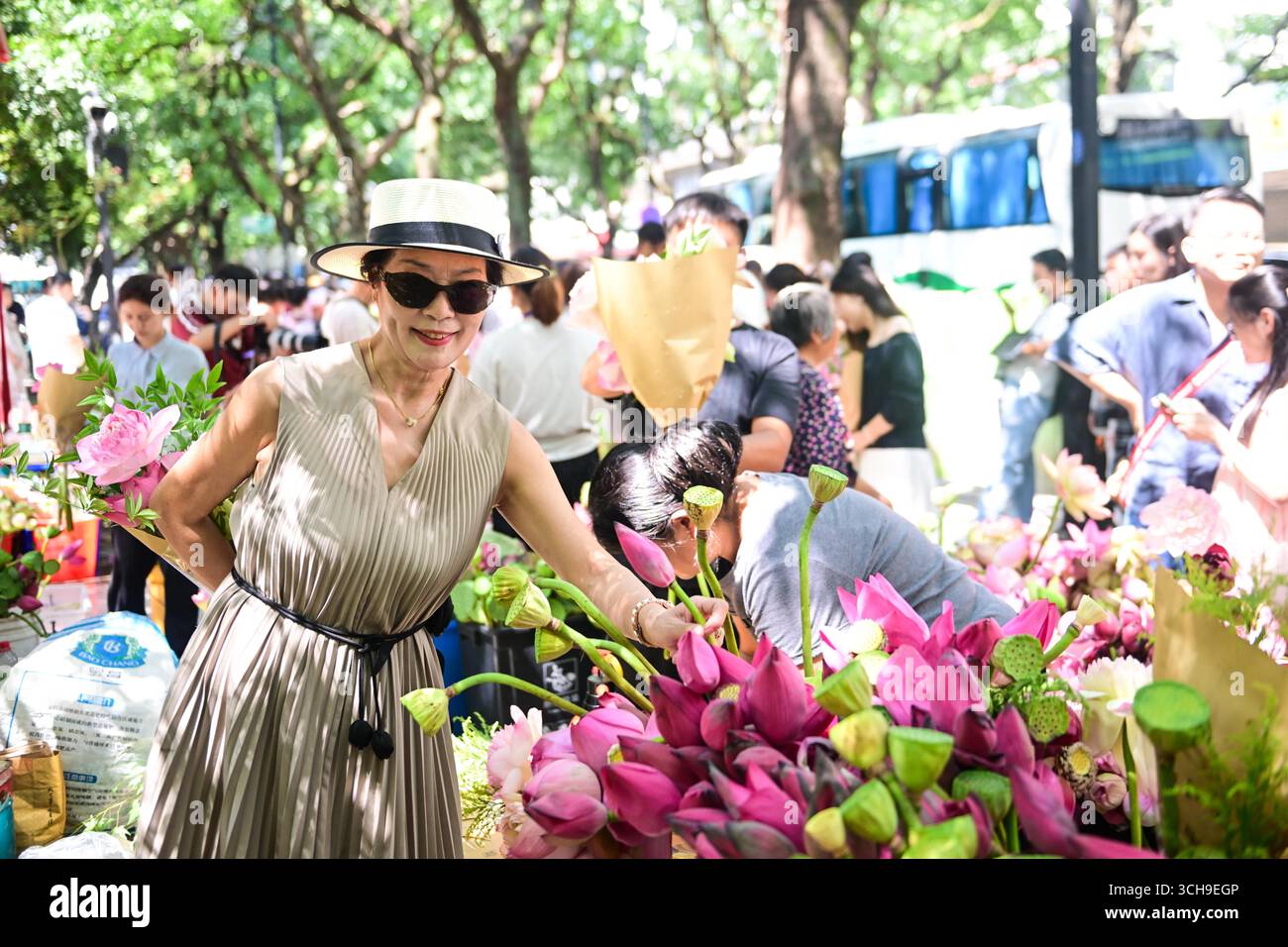 People buy lotus flowers at a lotus fair in Suzhou City, east China's ...