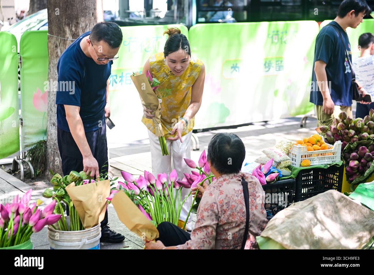 People buy lotus flowers at a lotus fair in Suzhou City, east China's ...