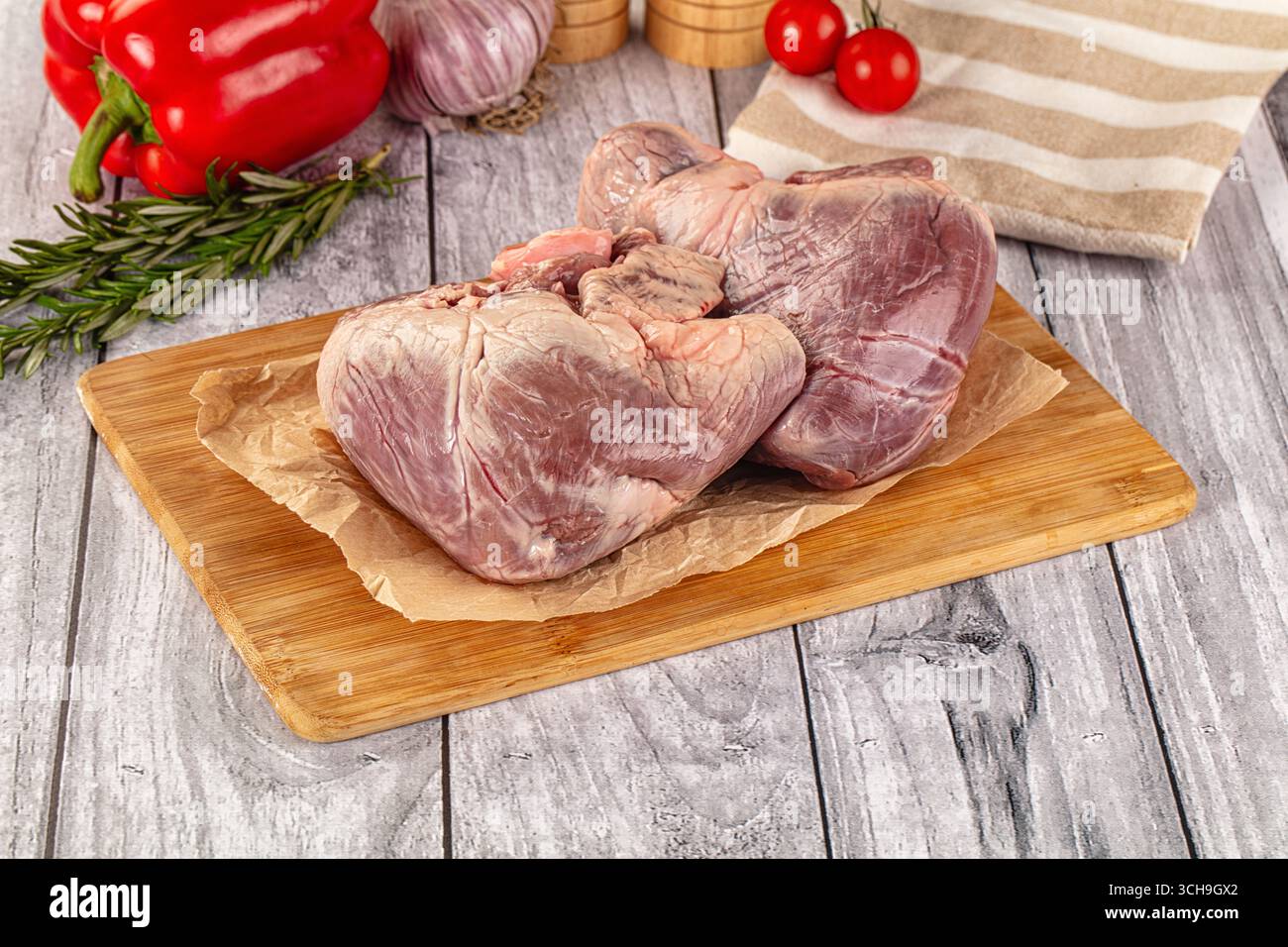 Uncooked raw fresh pork heart over board Stock Photo - Alamy