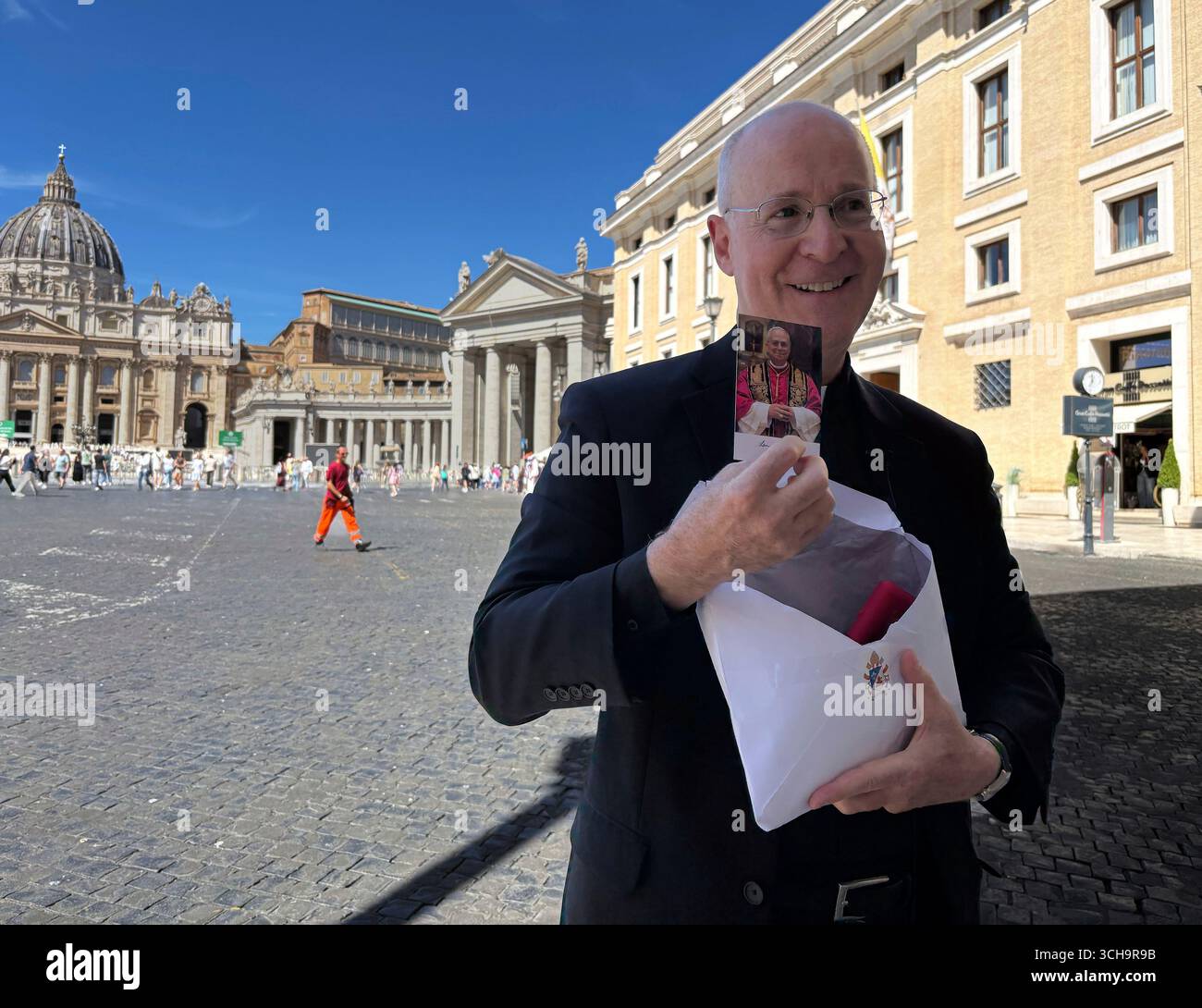 Rev. James Martin, a New York-based Jesuit, shows a commemorative ...