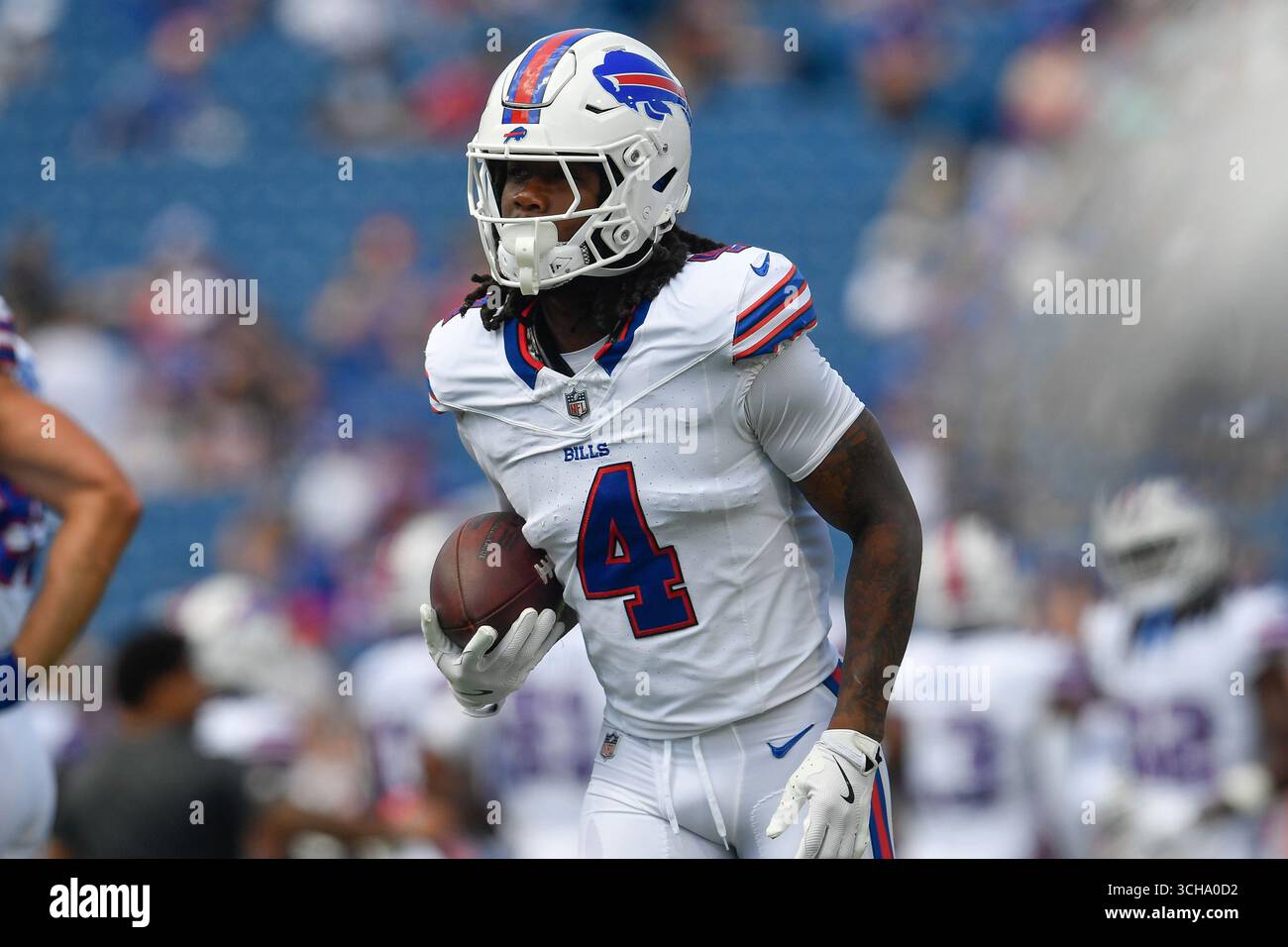 FILE - Buffalo Bills running back James Cook (4) warms up before an NFL ...
