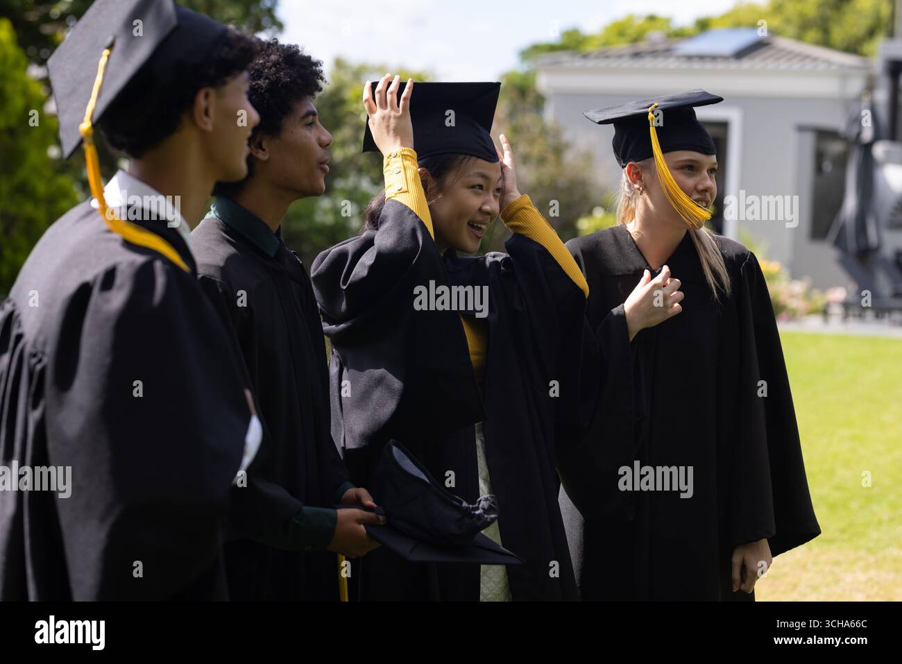 Graduating students adjusting caps hi-res stock photography and images ...