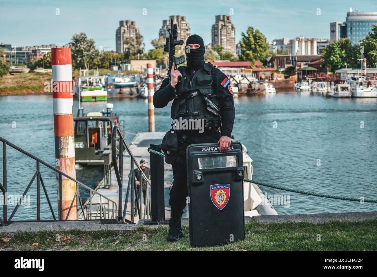 Member of a special police unit holding a shield and an automatic ...