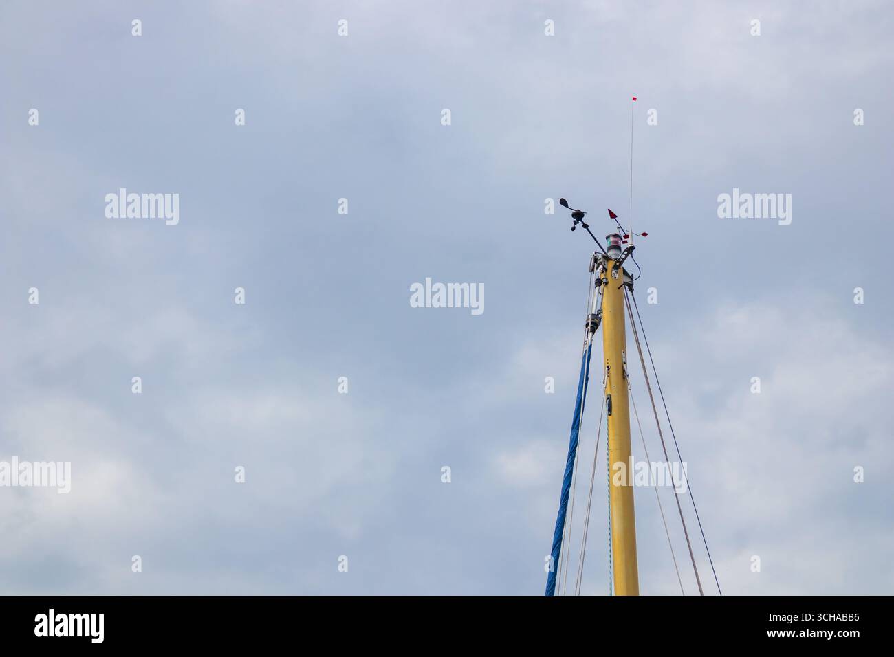 Wind indicator mounted on sailboat mast against sky. Sailing equipment ...