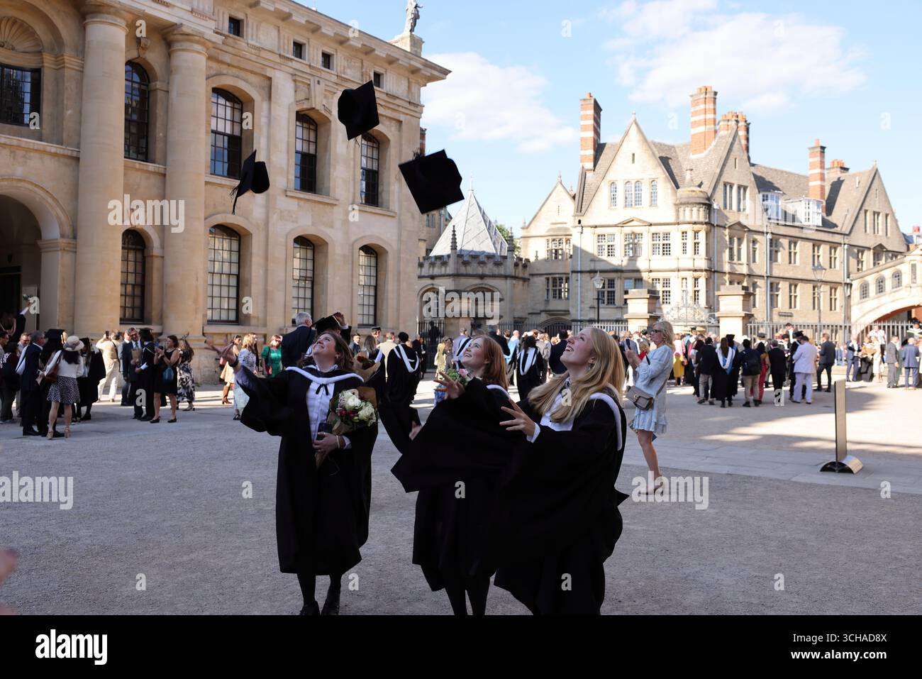 Students throwing their mortar boards in the air to celebrate ...