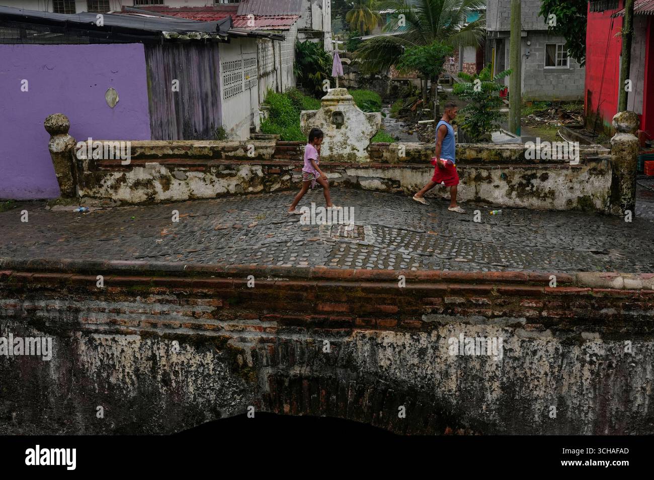Residents cross a colonial-era bridge in Portobelo, a town on Panama's ...