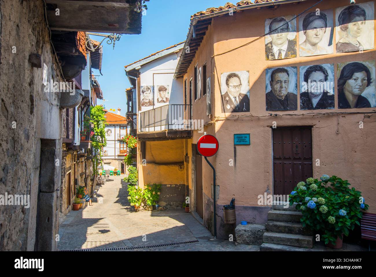 Street and portraits of neighbours on facades. Mogarraz, Sierra de ...