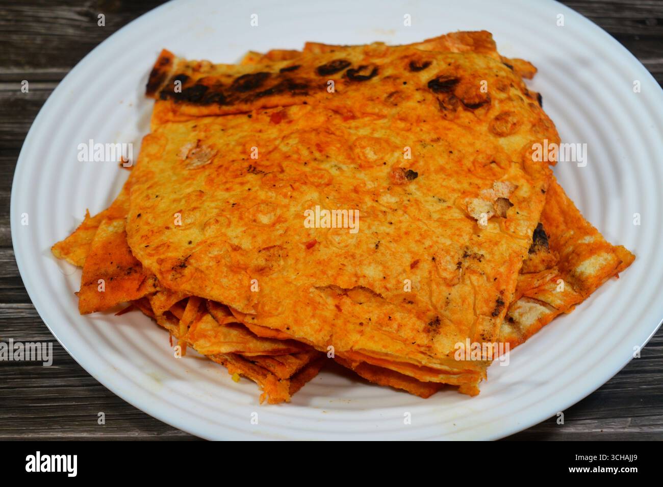 Folded Toasted thin tortilla bread in a pan, a thin, circular ...