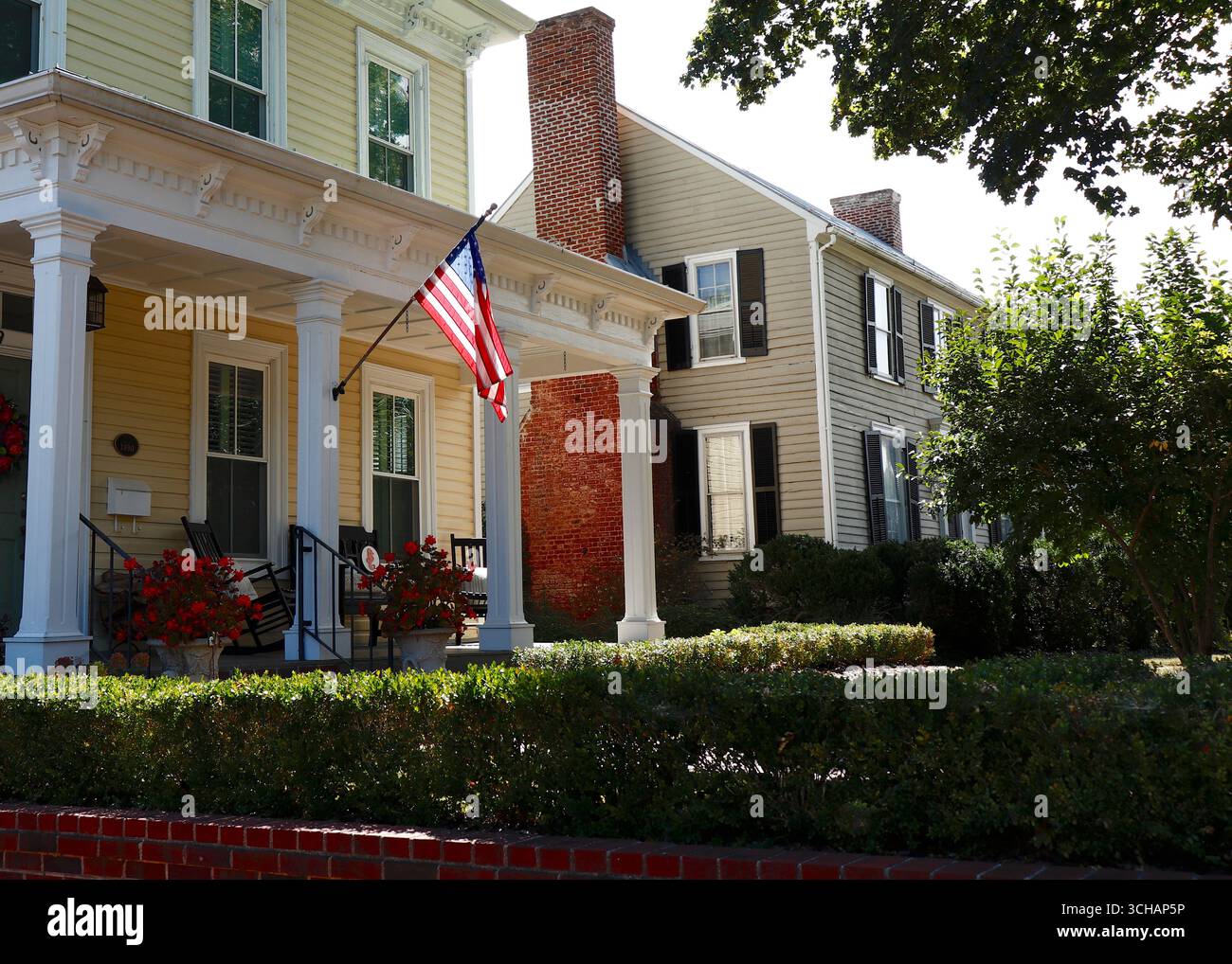 American Flag Flies on Colonial Style House Stock Photo - Alamy