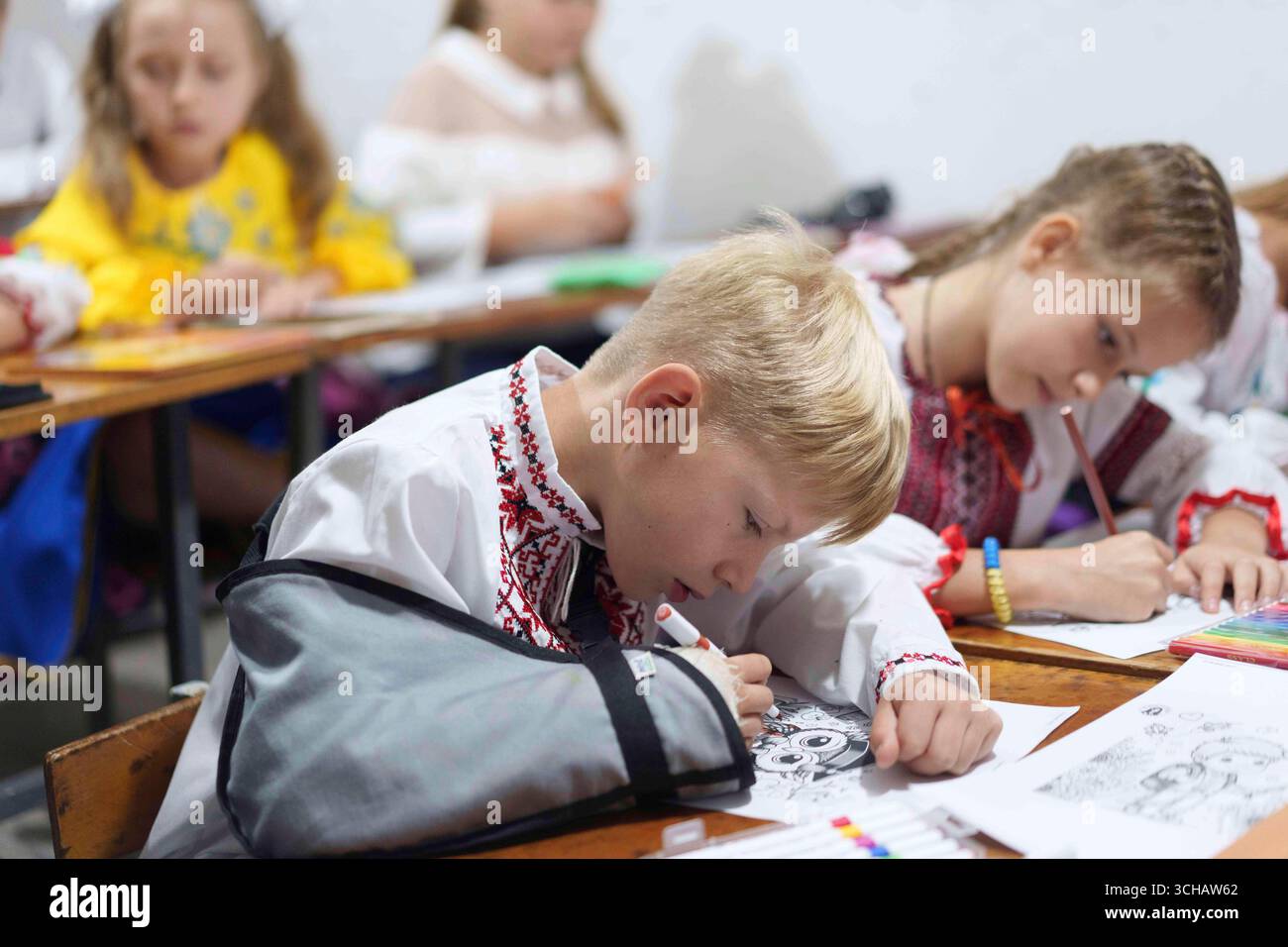 A school boy draws during a lesson, in the basement of a municipal ...