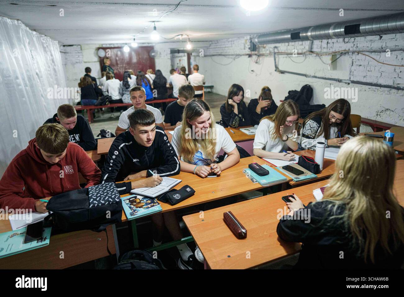 School students listen to their teachers during a lesson, in the ...