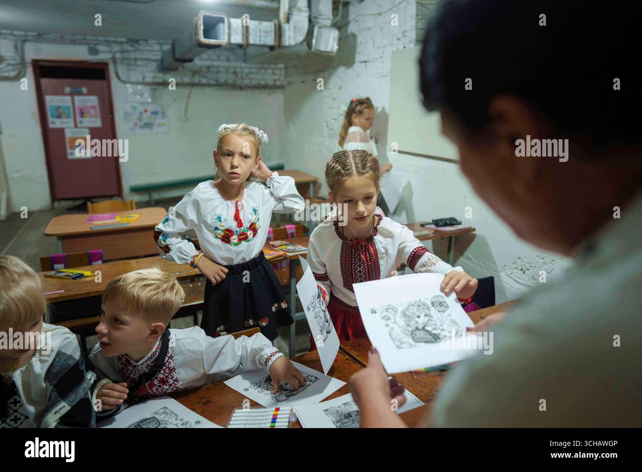 School students listen to their teacher during a lesson, in the ...