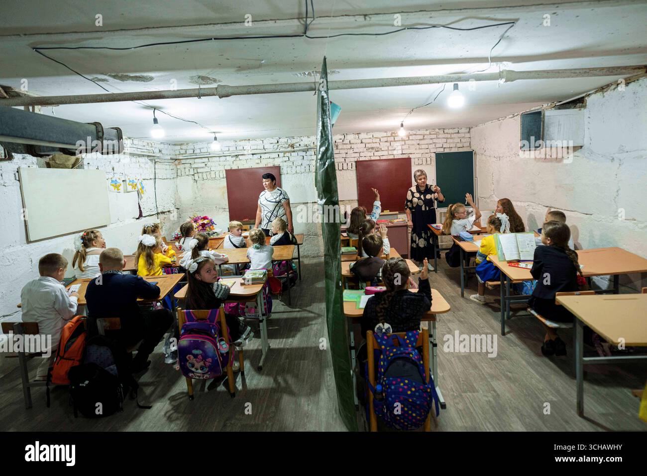 School students listen to their teachers during a lesson, in the ...