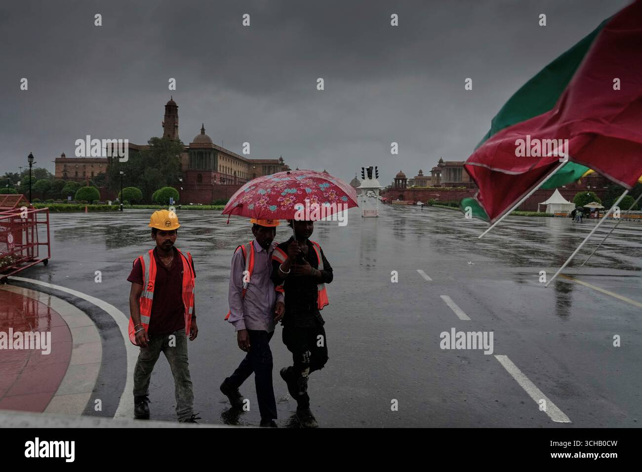 Construction workers walk across Raisina Hill, the seat of government ...