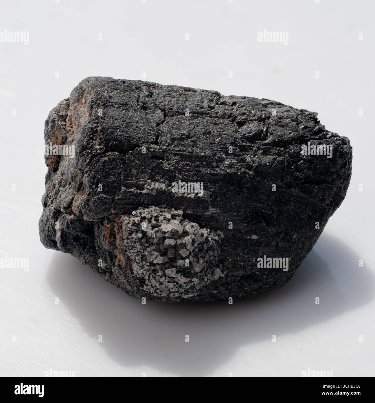 Close-up view of a rough, naturally formed black tourmaline crystal ...