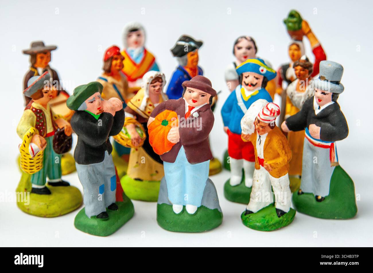Colorful terracotta Santons figurines depict various characters from ...