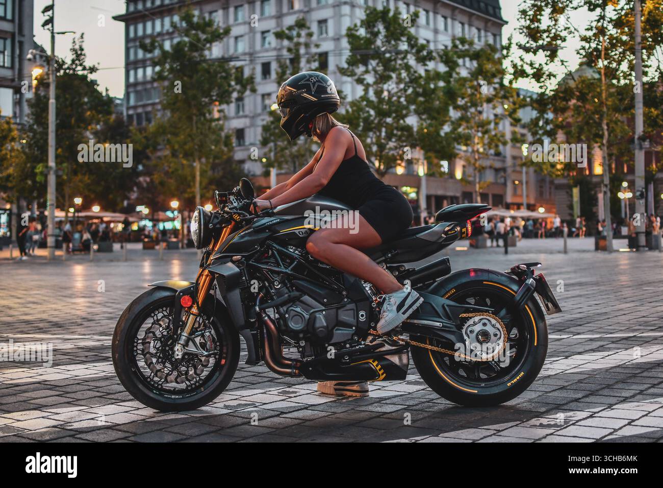 Young woman riding a limited edition Augusta Rush motorcycle on city ...
