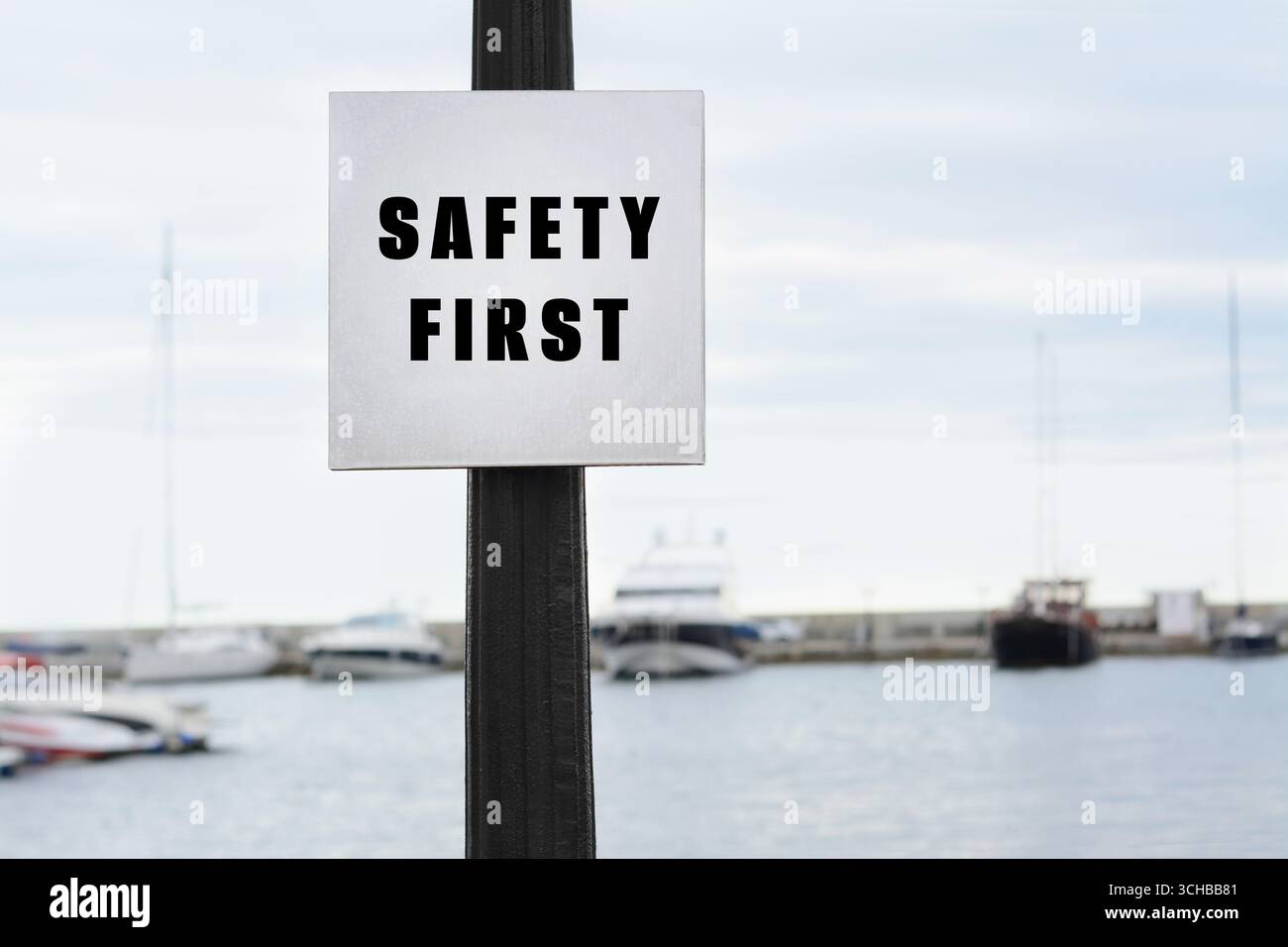 Safety First sign on pole near bay outdoors Stock Photo - Alamy