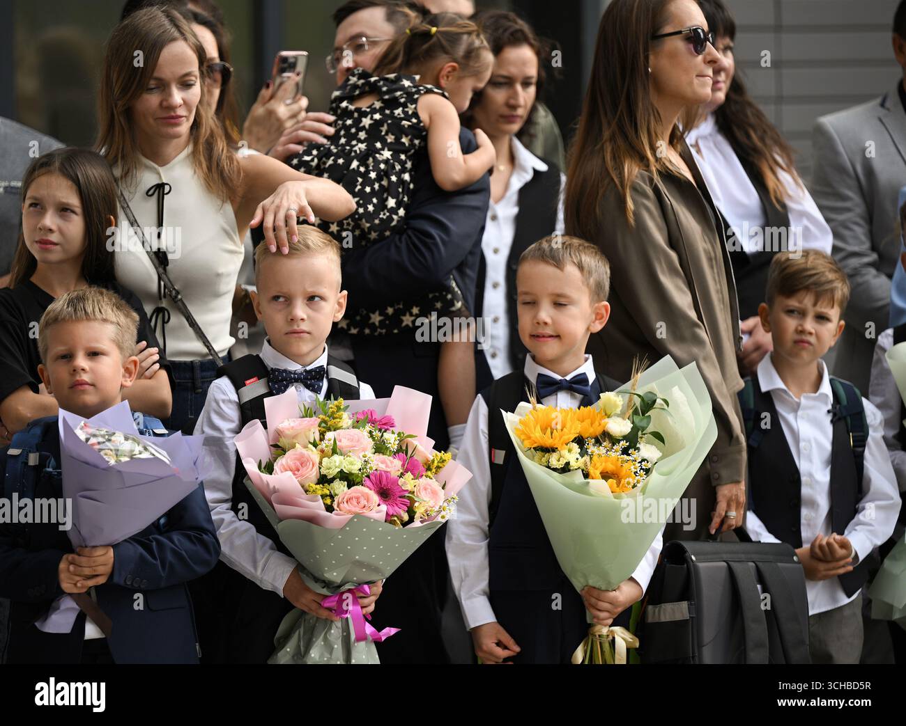 First-graders with their parents before the start of the ceremonial assembly dedicated to the ...