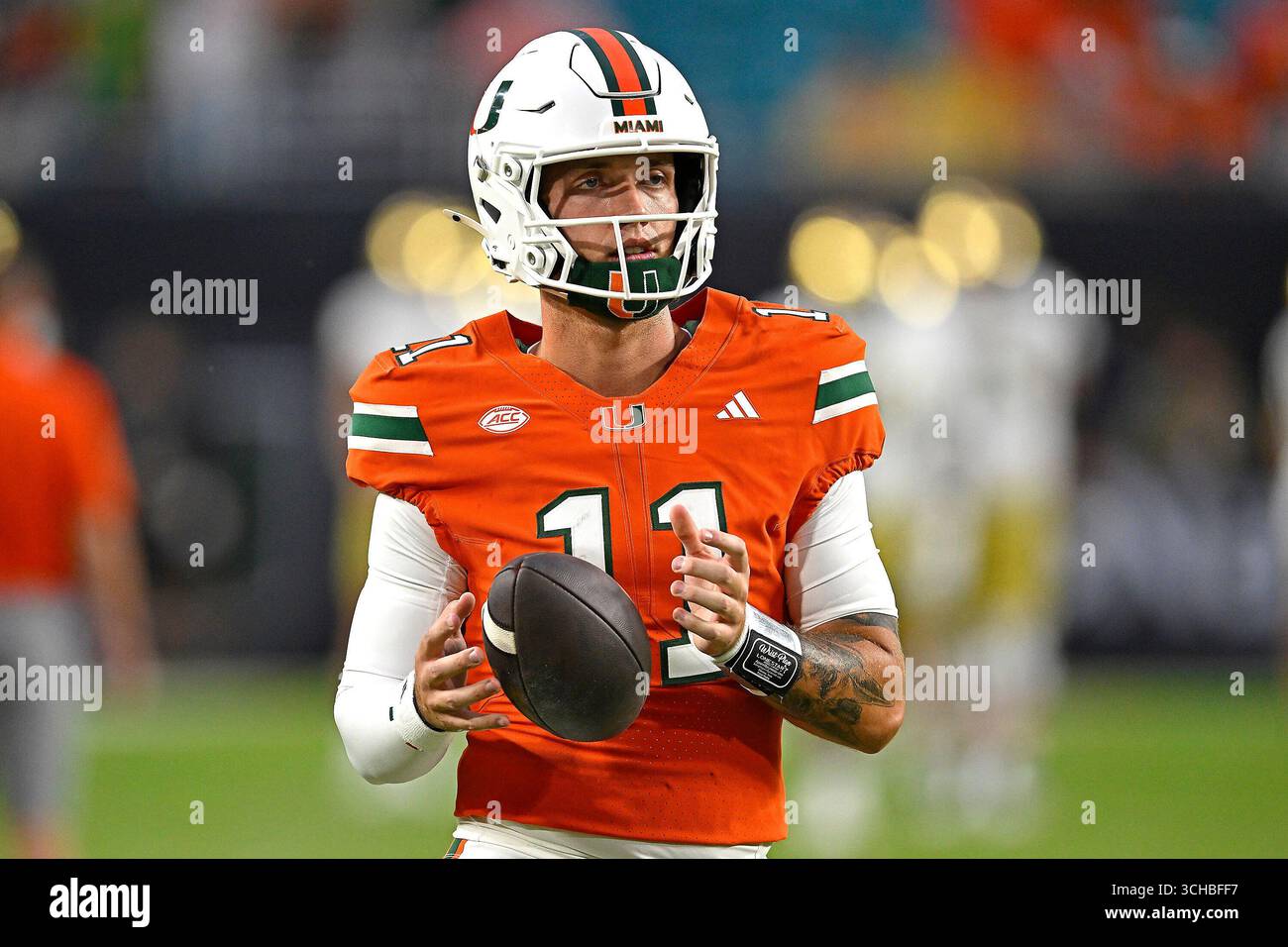 MIAMI GARDENS, FL - AUGUST 31: Miami quarterback Carson Beck (11) warms ...