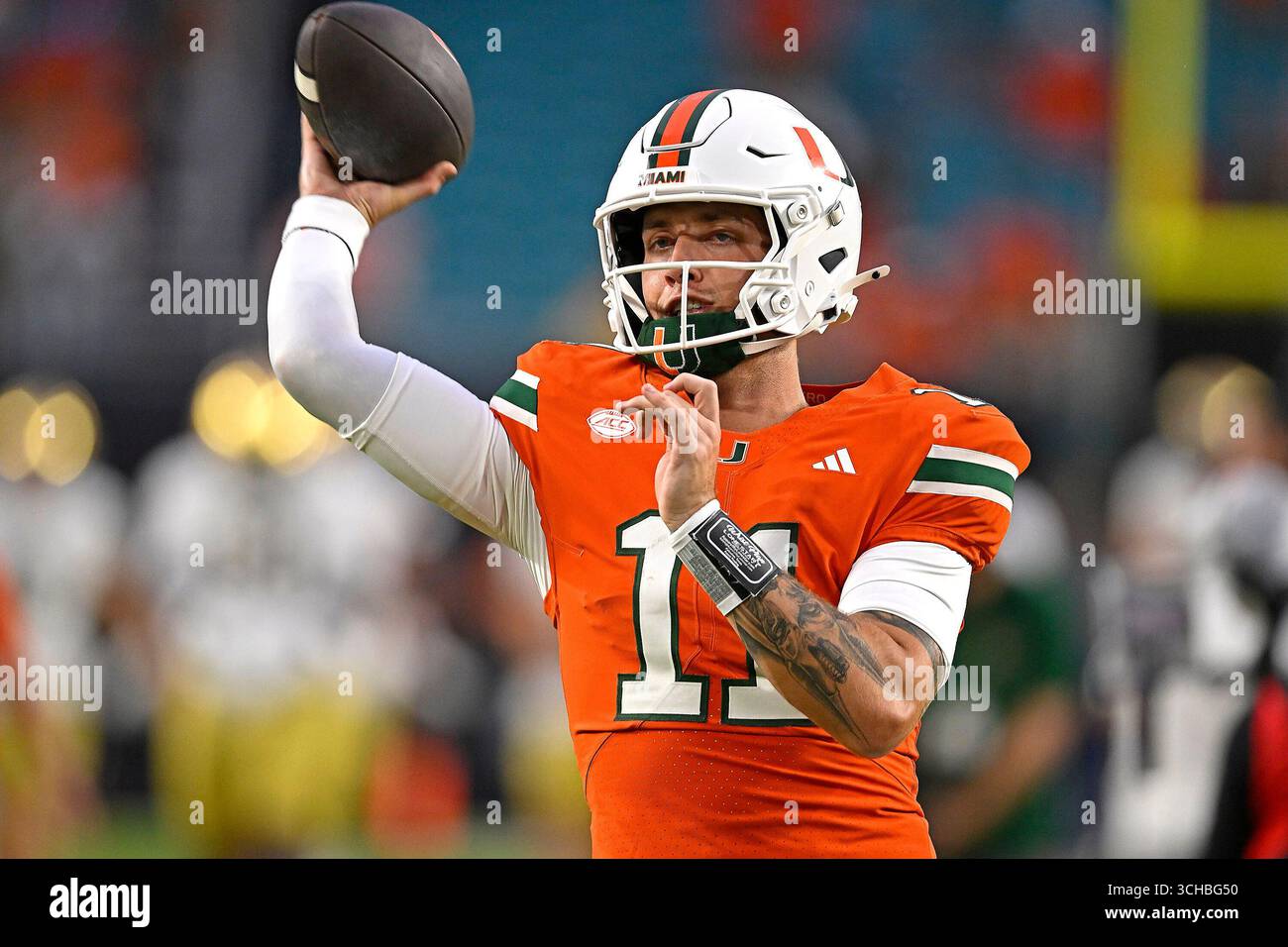 MIAMI GARDENS, FL - AUGUST 31: Miami quarterback Carson Beck (11) warms ...