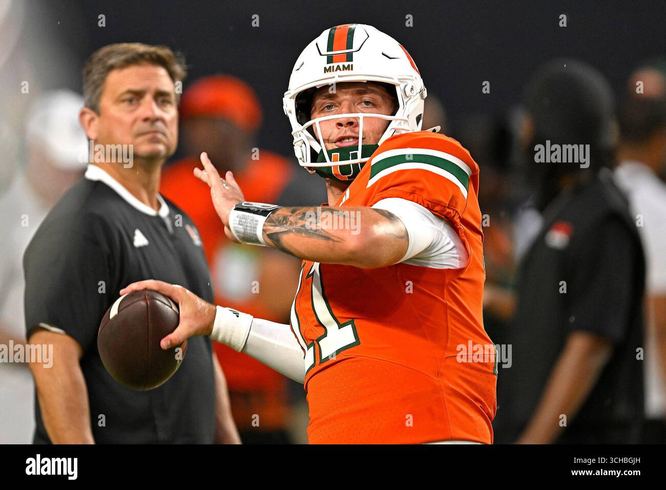 MIAMI GARDENS, FL - AUGUST 31: Miami quarterback Carson Beck (11) warms ...