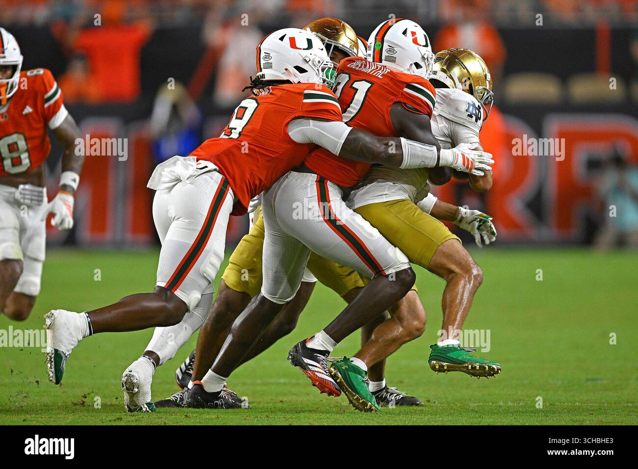 MIAMI GARDENS, FL - AUGUST 31: Miami linebacker Wesley Bissainthe (31) and linebacker Malik ...